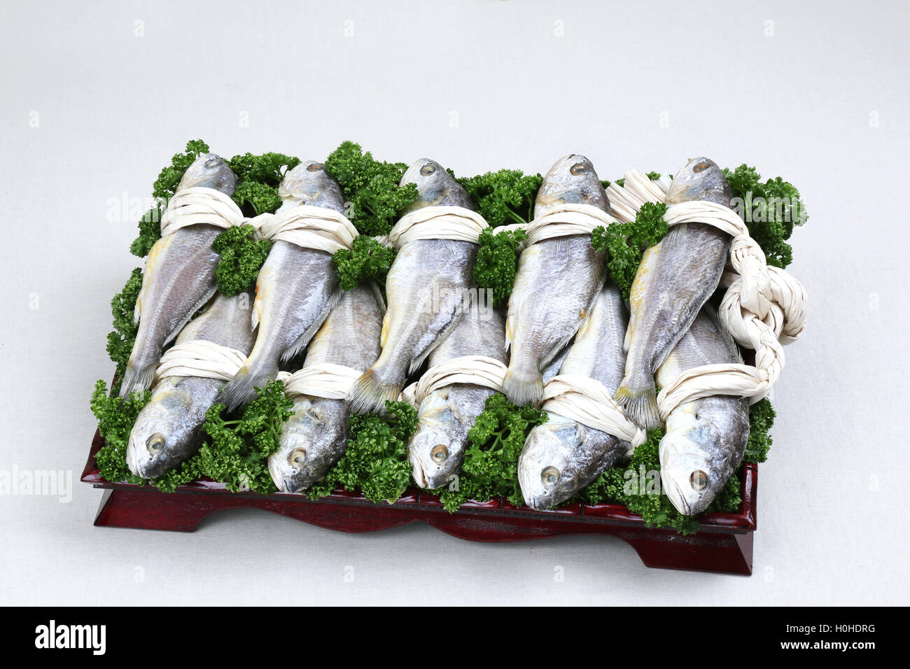 Glory set of gulbi fish on black plate in white background Stock Photo ...
