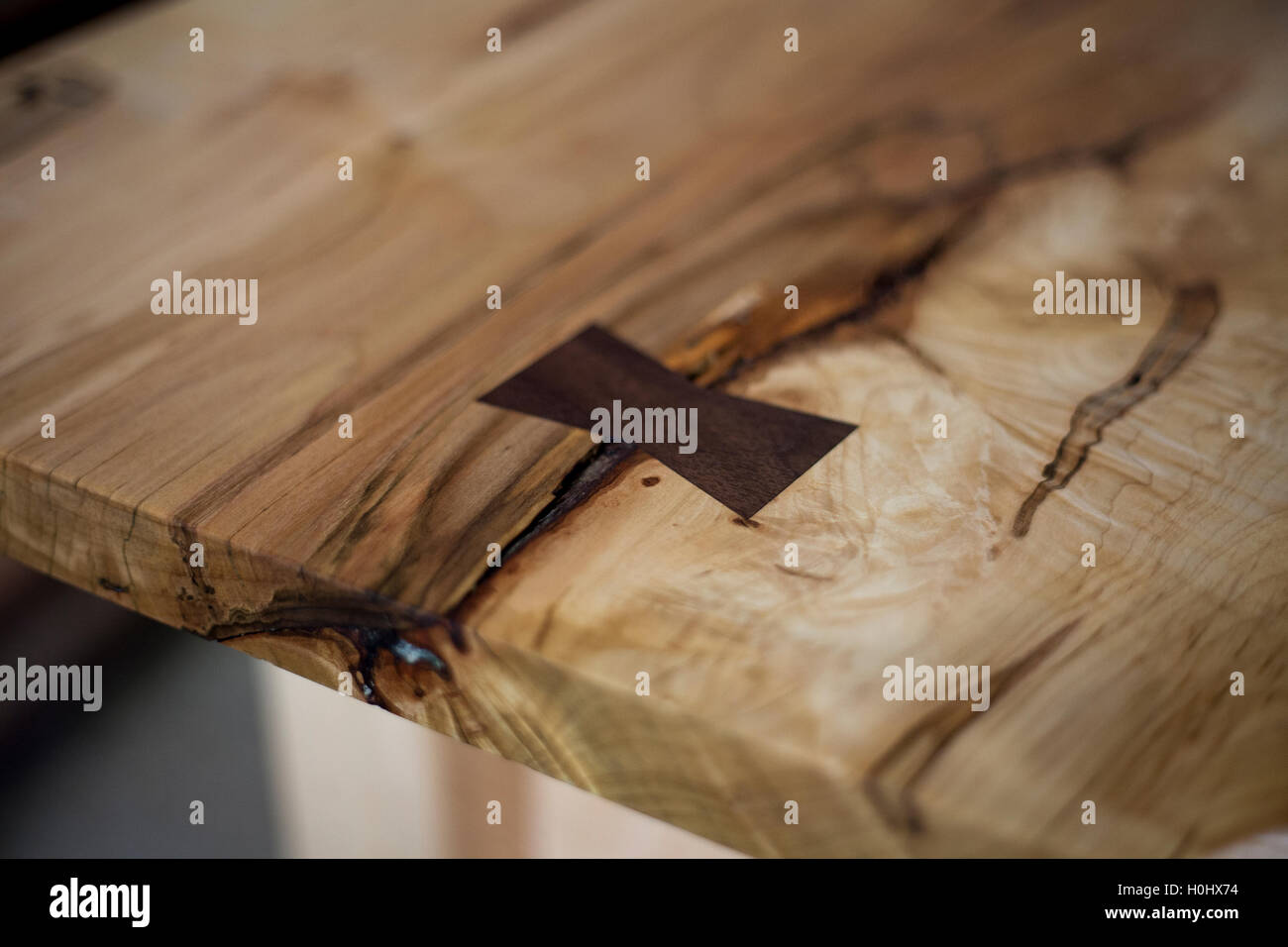 Custom wood table top awaiting assembly in shop Stock Photo - Alamy
