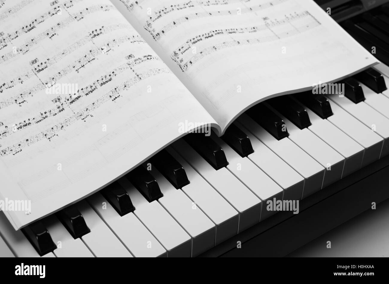 Piano keys and musical book Stock Photo - Alamy
