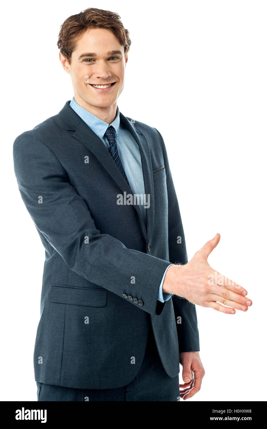 Executive welcoming you with a handshake Stock Photo - Alamy