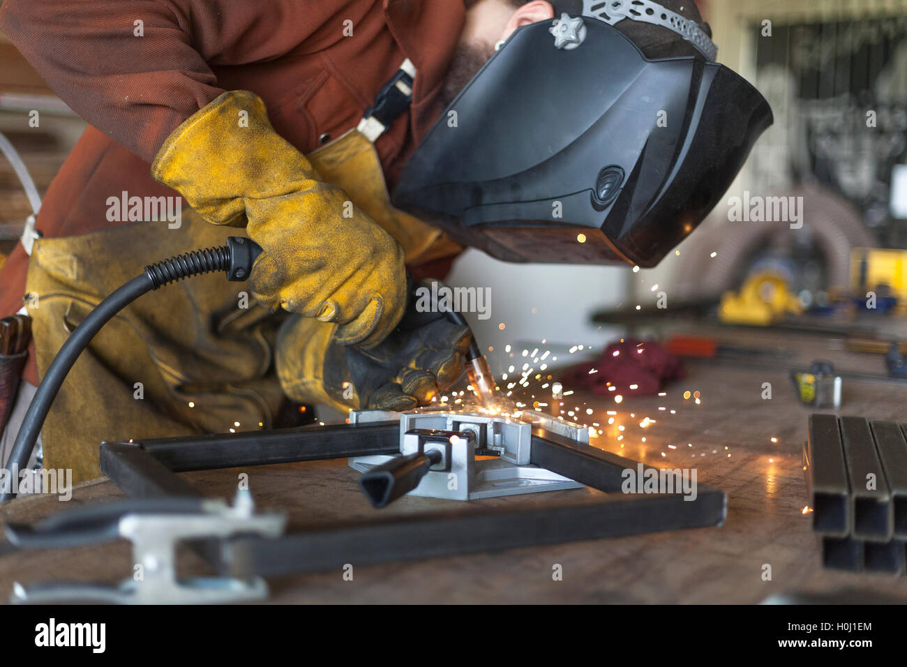 Welder welding steel stool support to each other Stock Photo - Alamy
