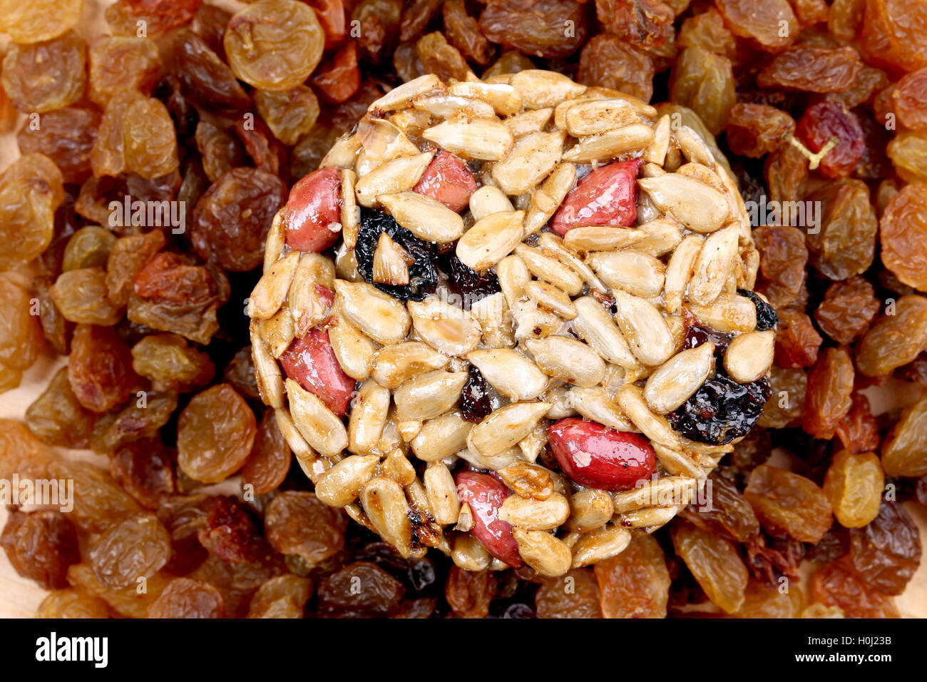 Round candied seeds and nuts with raisins Stock Photo - Alamy