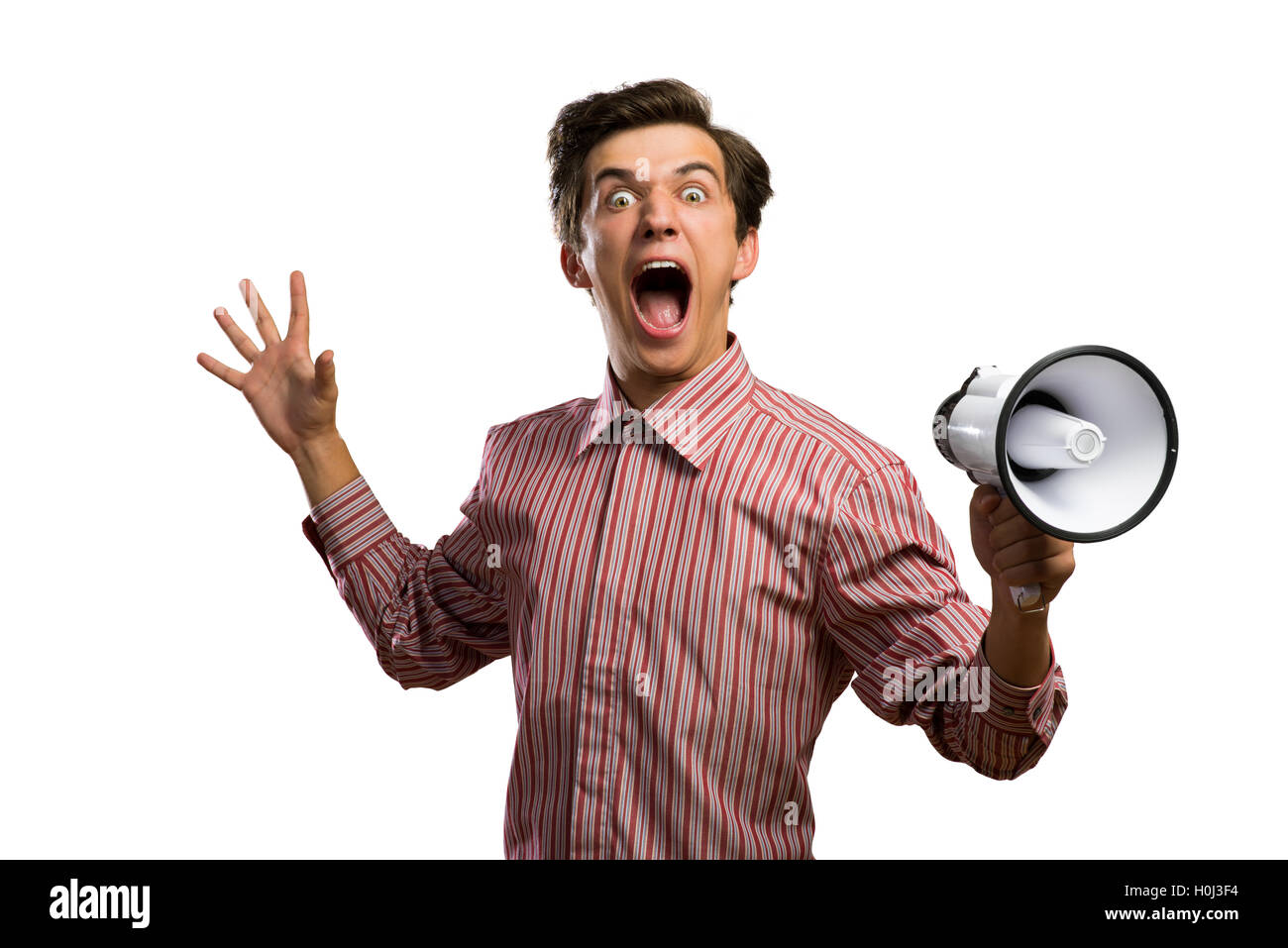 Portrait of a young man shouting using megaphone Stock Photo - Alamy