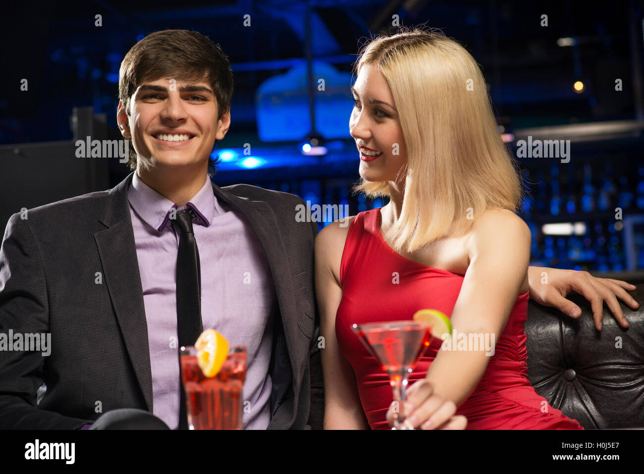 Young couple talking in a nightclub Stock Photo - Alamy