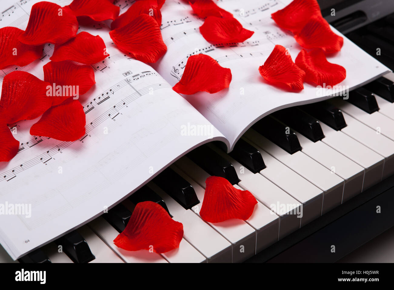 Piano keys and musical book Stock Photo - Alamy