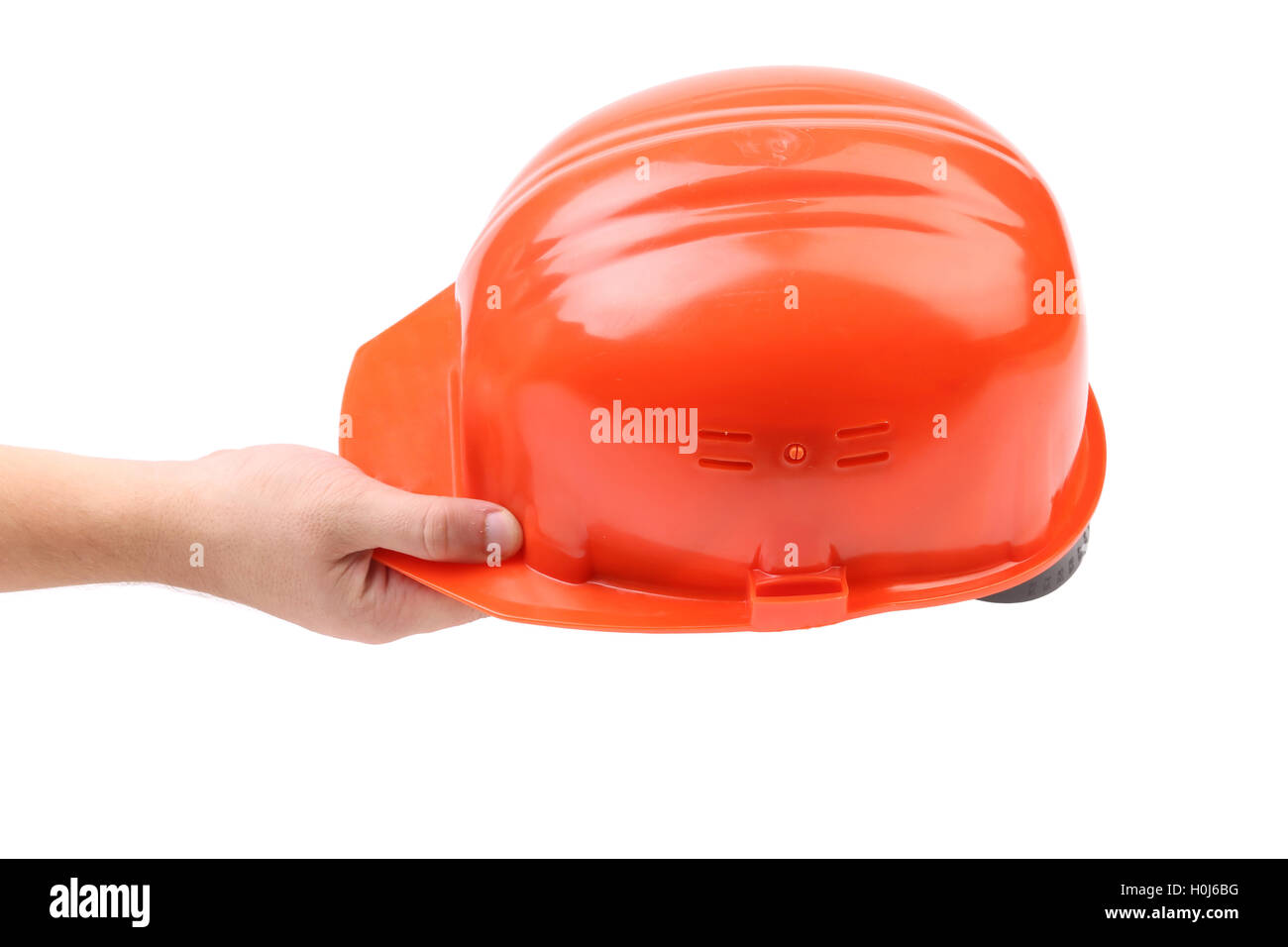 Hand holding red helmet over white Stock Photo - Alamy