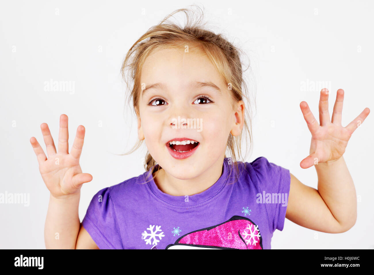 Cute little girl playing trick Stock Photo - Alamy