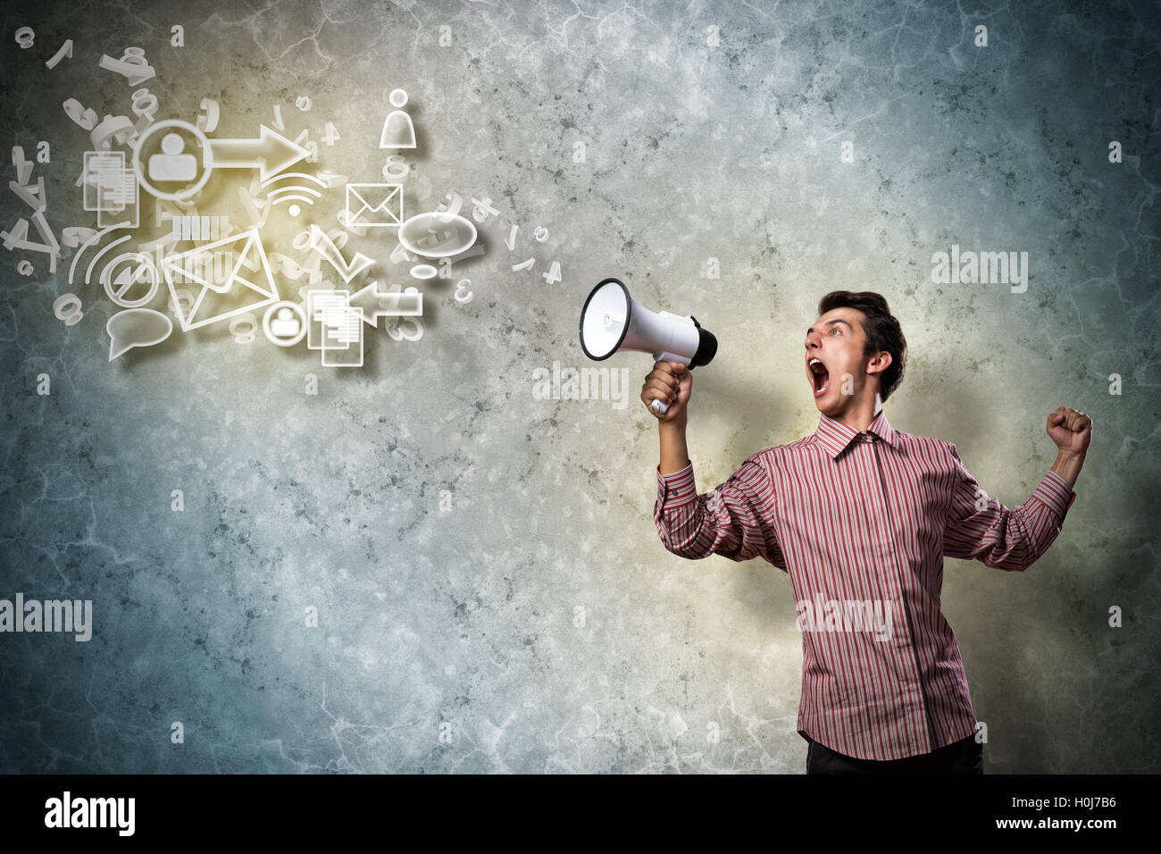 Portrait of a young man shouting using megaphone Stock Photo - Alamy
