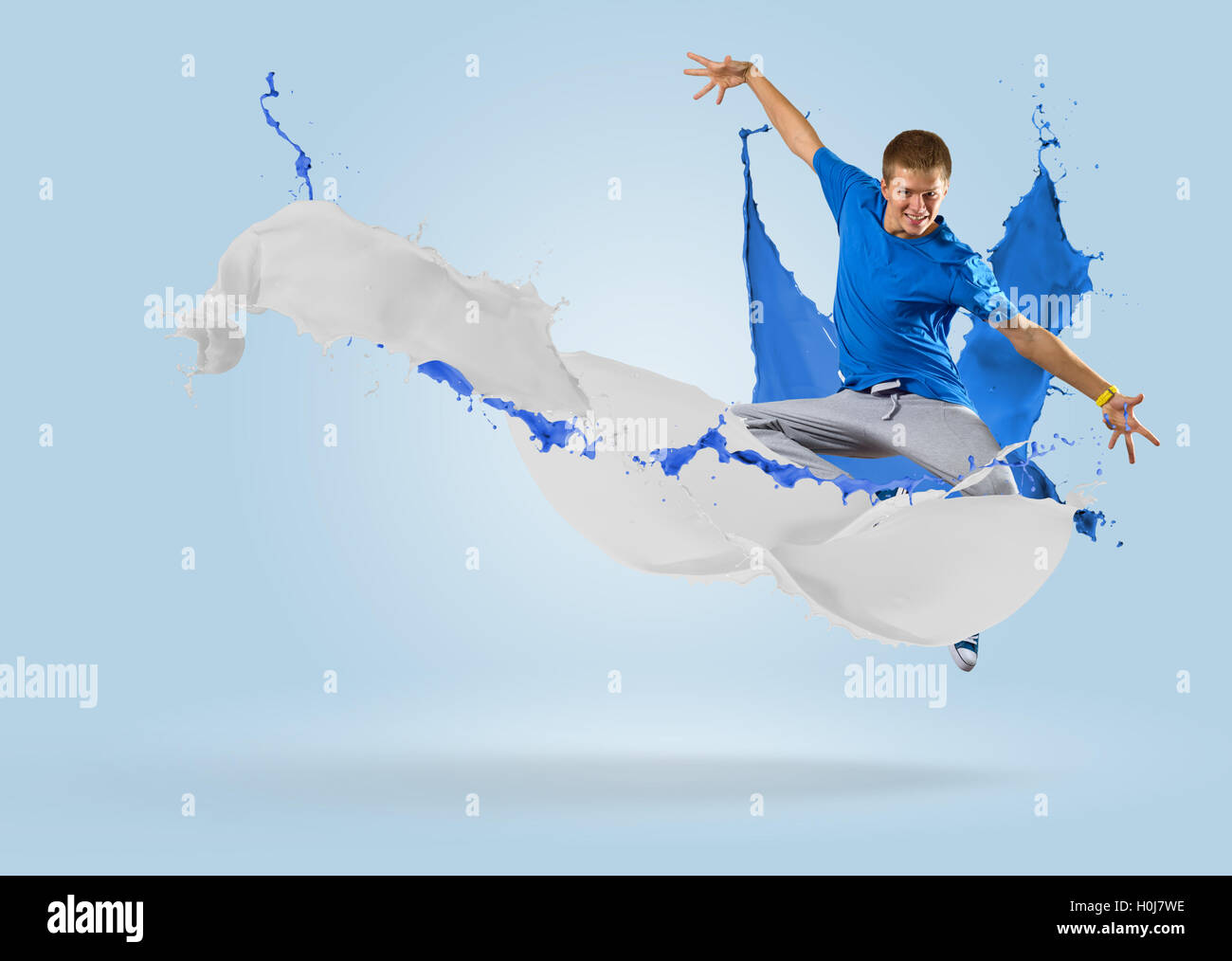 young male dancer jumping with splash of paint Stock Photo - Alamy