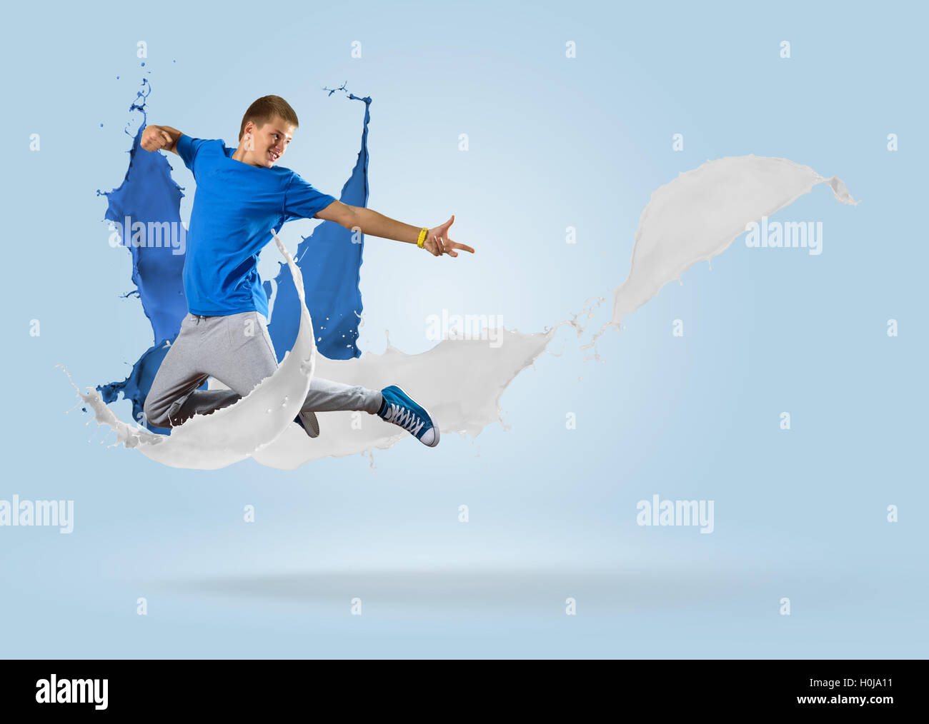 young male dancer jumping with splash of paint Stock Photo - Alamy