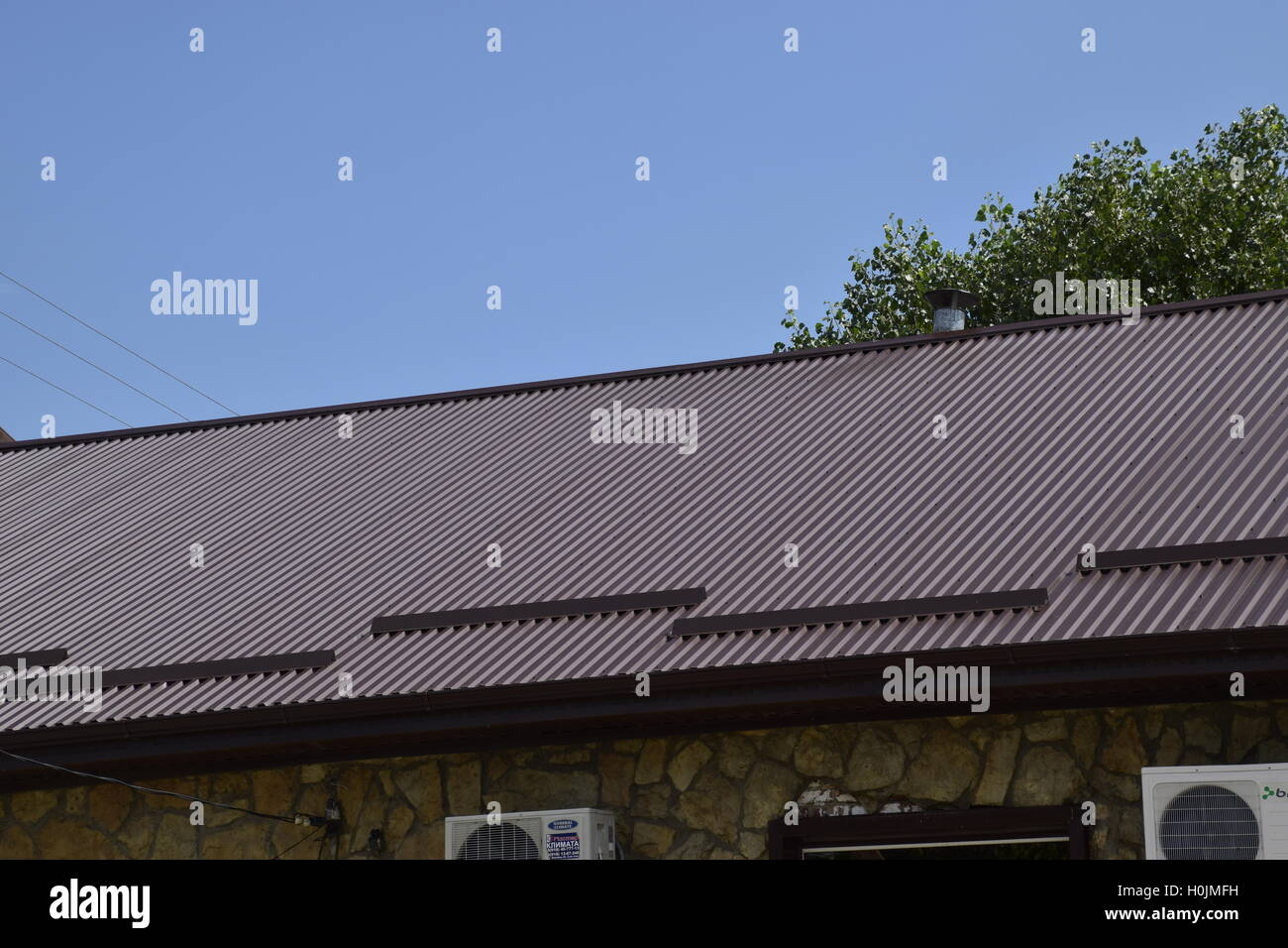 The roof of corrugated sheet. Roofing of metal profile wavy shape Stock ...