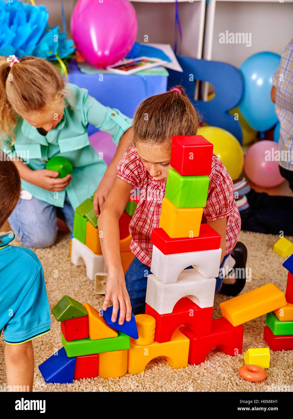 Group children game blocks on floor Stock Photo - Alamy