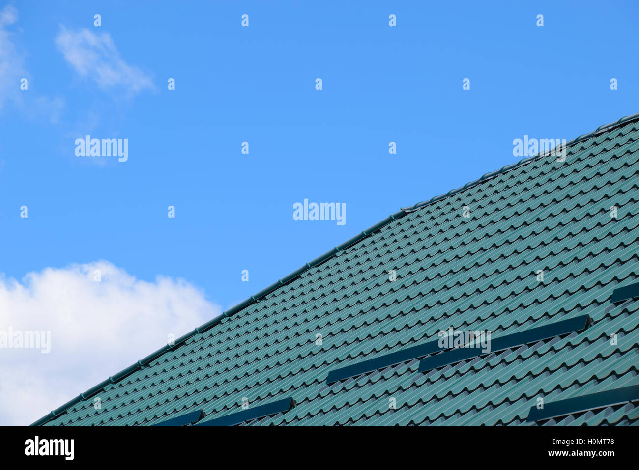 The roof of corrugated green sheet. Roofing of metal profile wavy shape ...