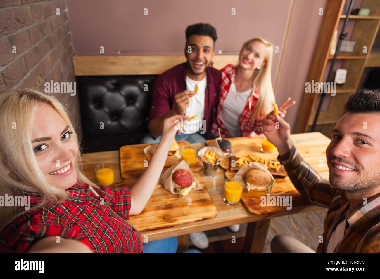 People Group Eating Fast Food Burgers Potato Sitting At Wooden Table In ...
