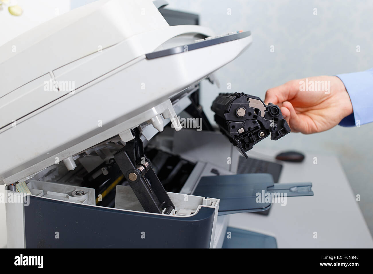 Male hand holding color printer toner Stock Photo - Alamy