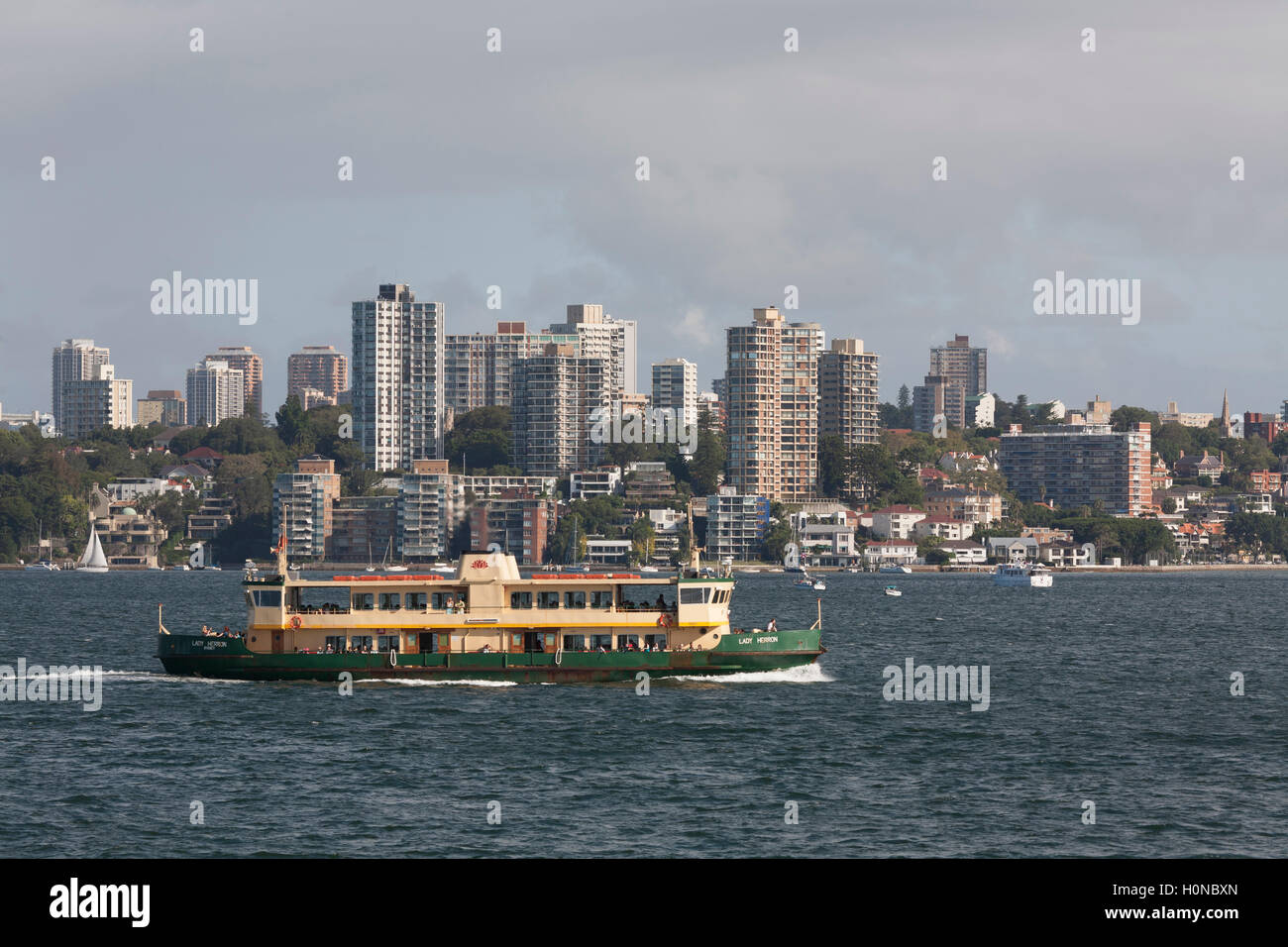Sydney Harbour Ferry Lady Herron passing the harbour side suburb of ...