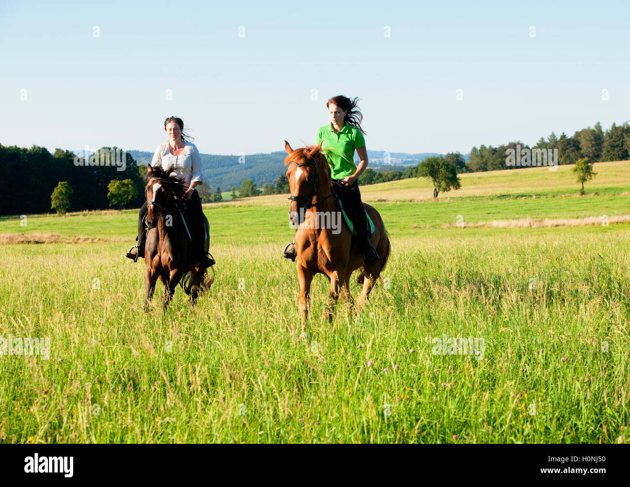 Two women riding horses hi-res stock photography and images - Alamy
