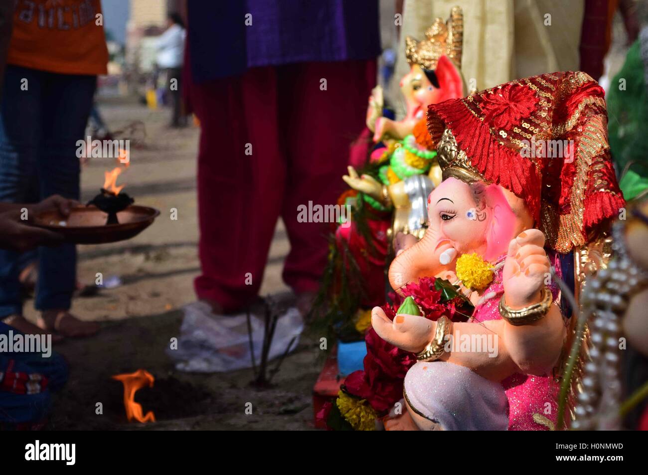 Devotees perform pooja before carrying an idol of elephant headed Hindu ...