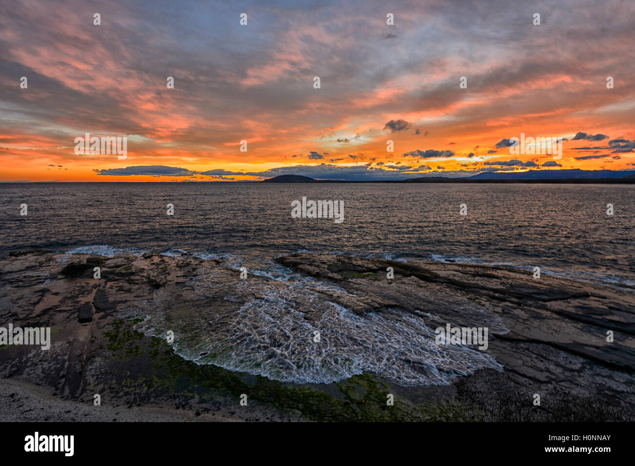 Fiery sunset and motion blur at Black Head Point, Gerroa Headland, New ...