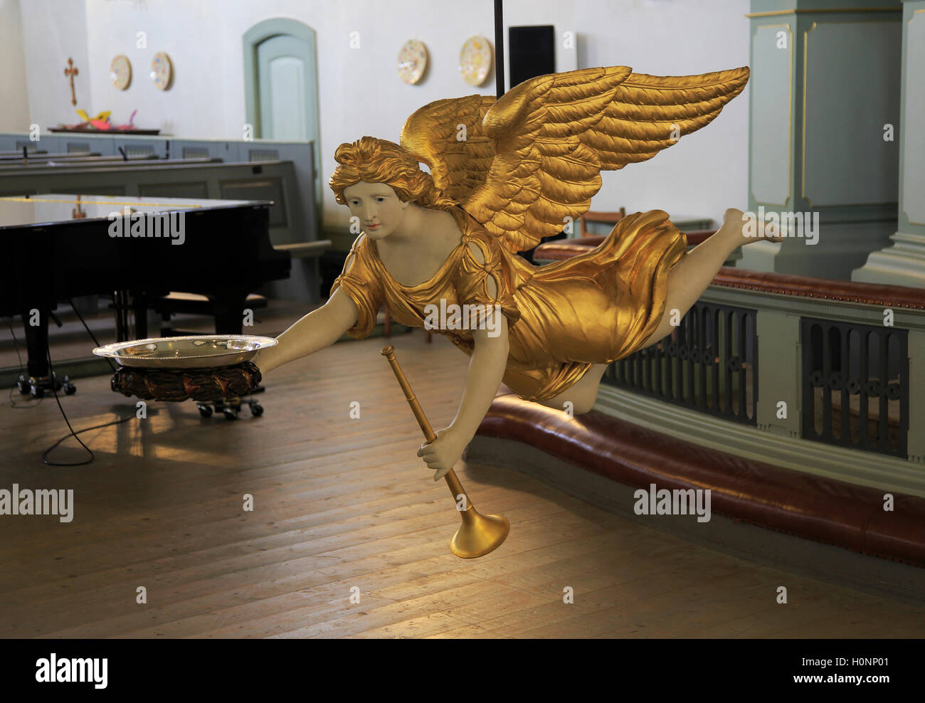 Golden angel figure inside historic Nykirken church, city of Bergen ...