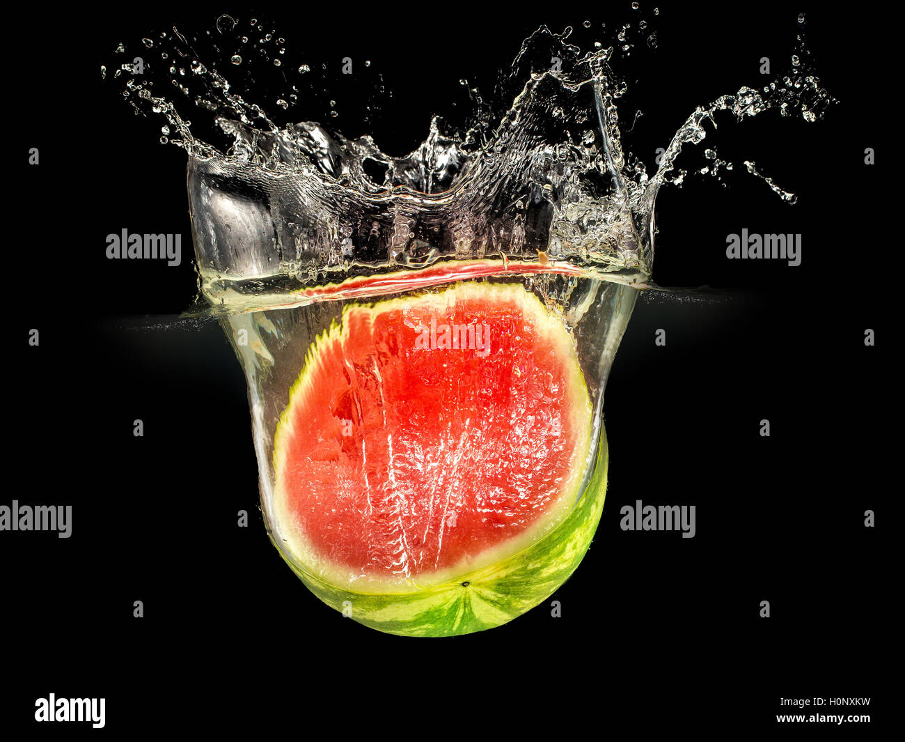 Fresh melon falling in water with splash on black Stock Photo - Alamy