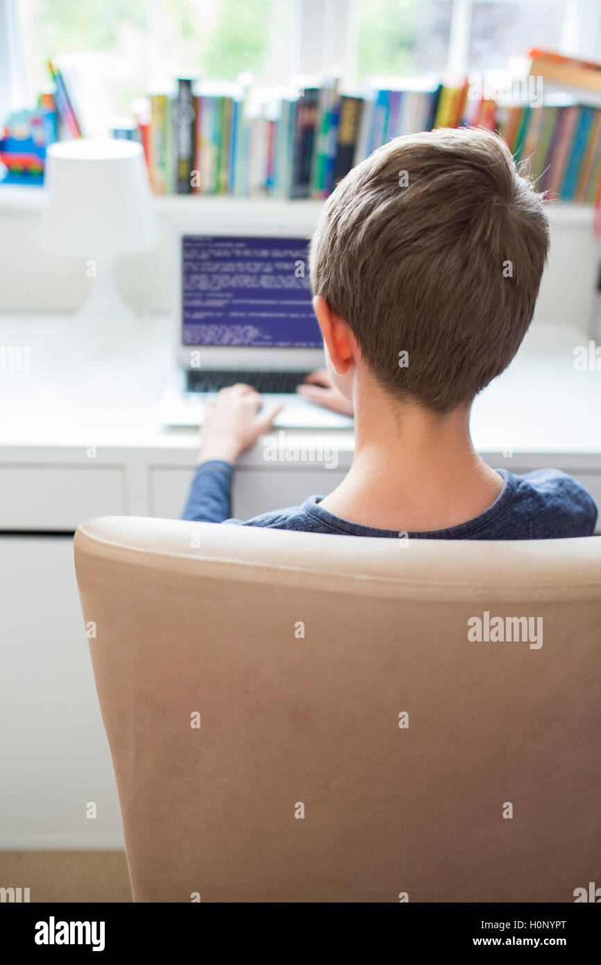 Teenage Boy In Bedroom Writing Computer Code Stock Photo - Alamy
