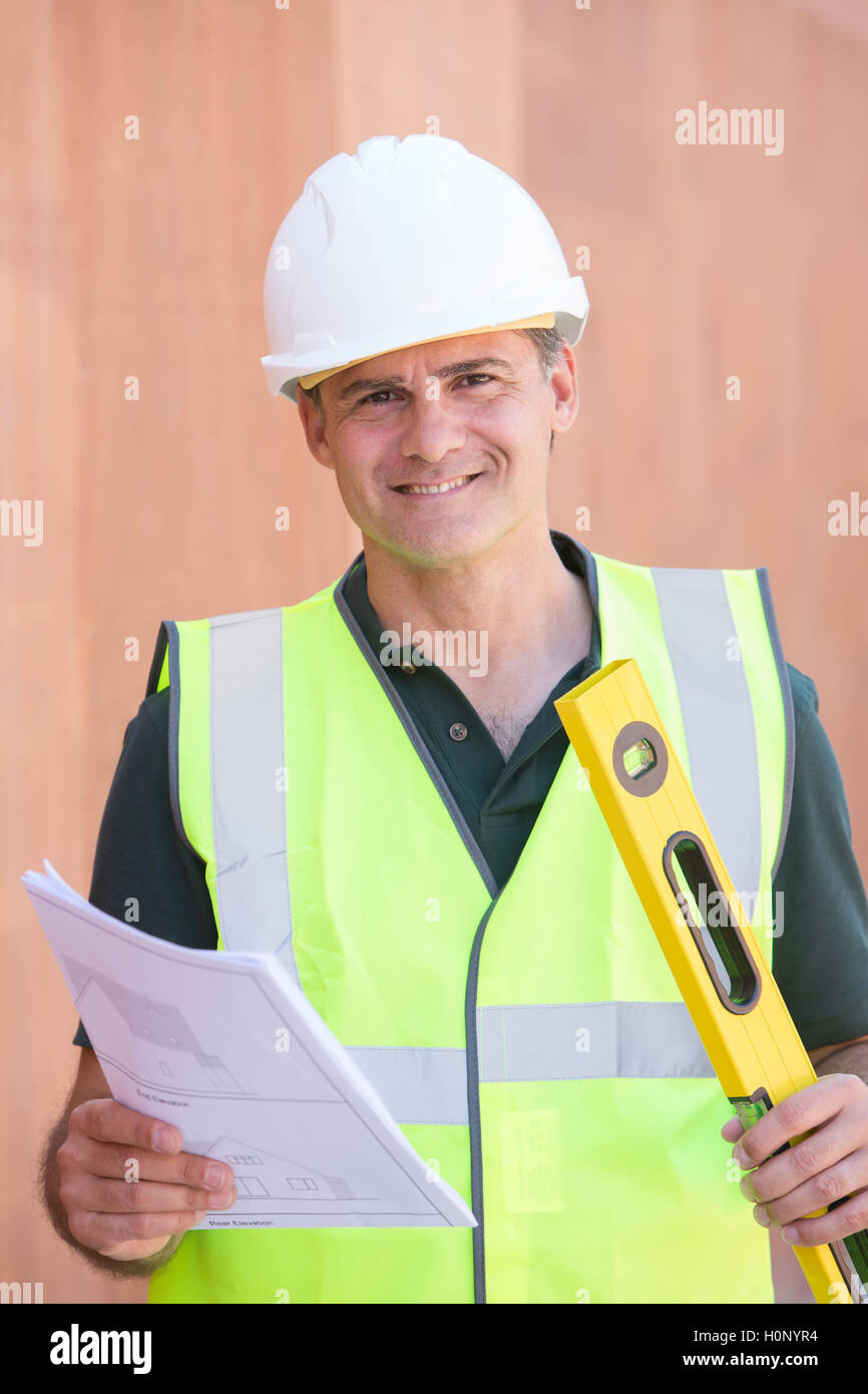 Portrait Of Construction Worker On Building Site With House Plans Stock ...