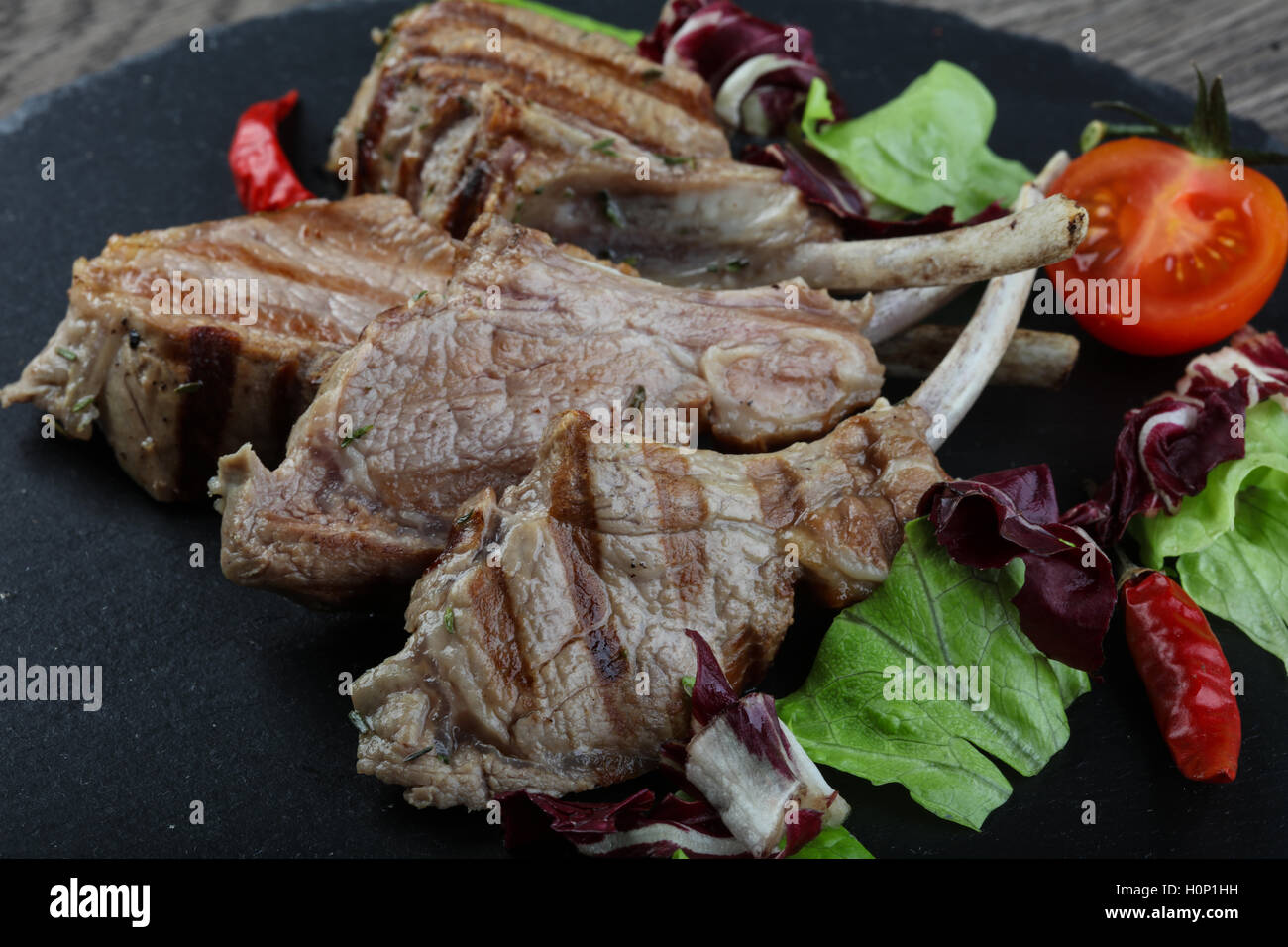 Lamb Frenched Rack grilled rib bone Stock Photo - Alamy