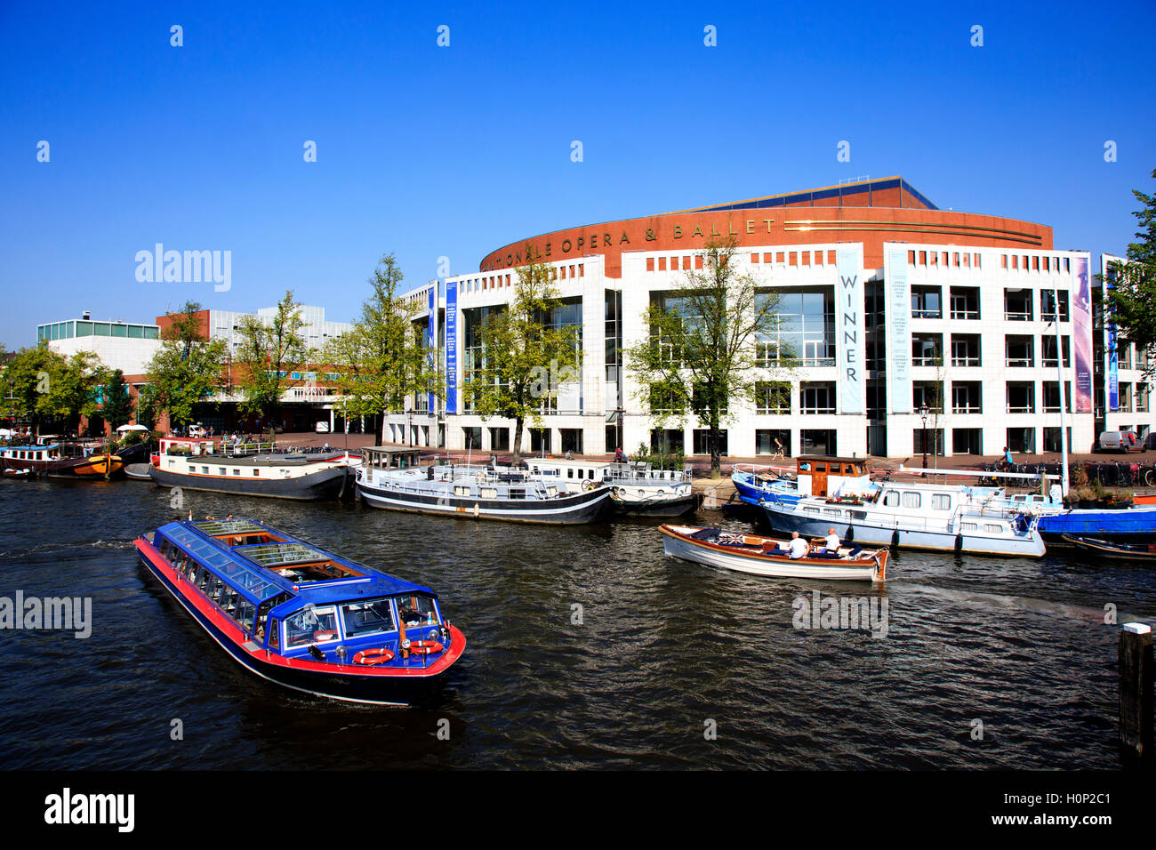 Tourist Boats passing the Amsterdam Nationale Opera & Ballet house ...