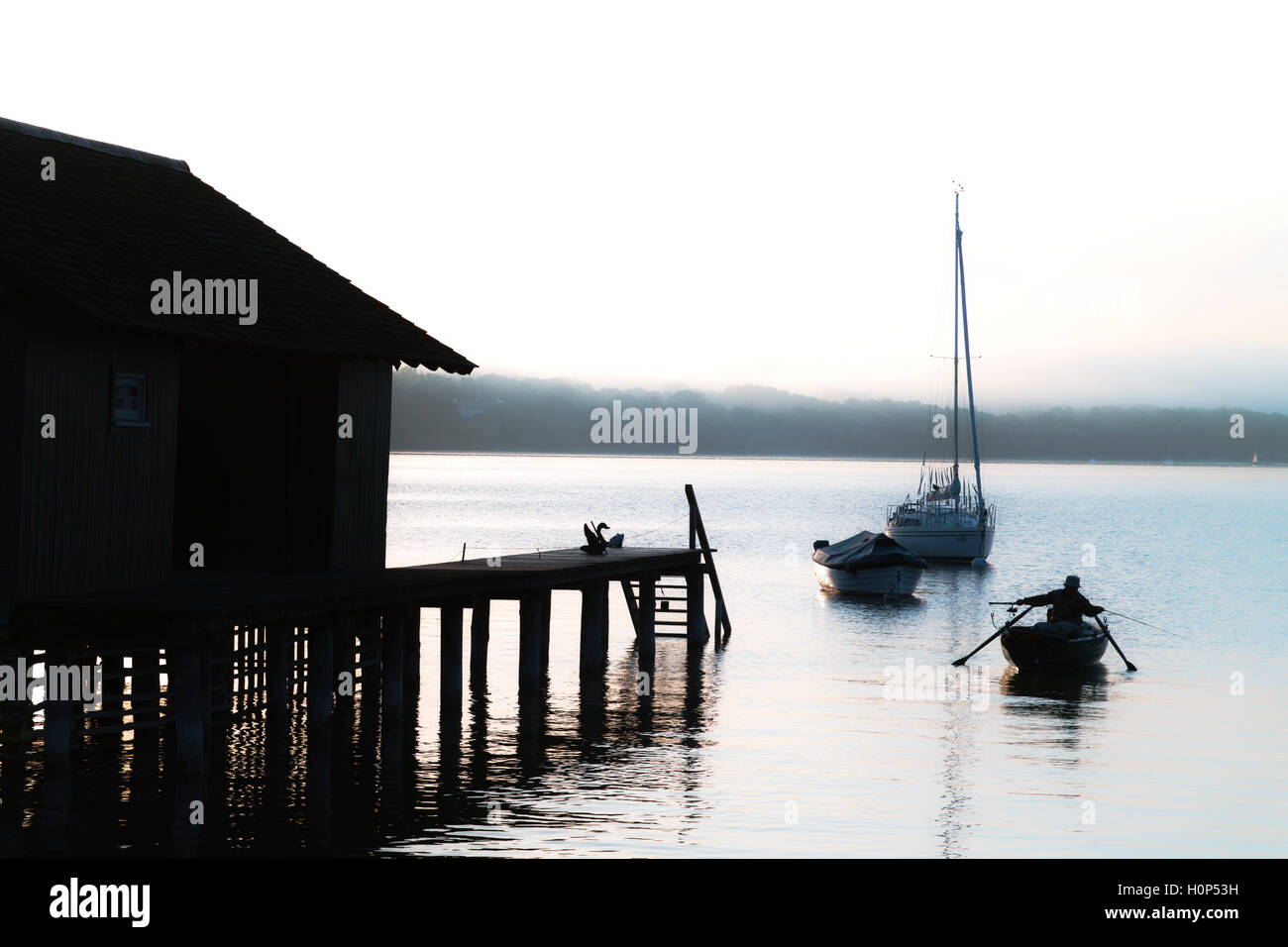 lake at dawn, rowing boat setting off Stock Photo - Alamy