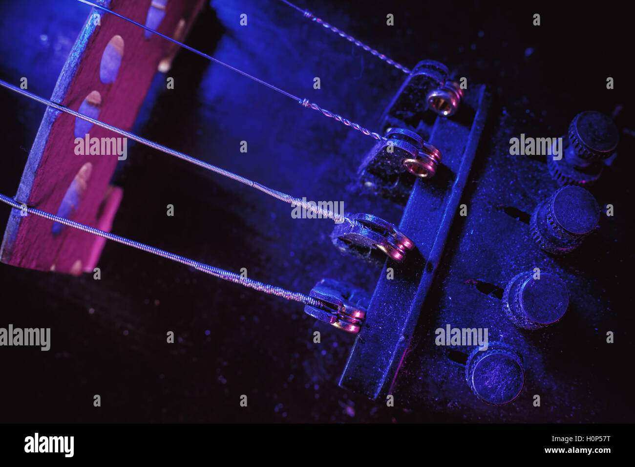 Studio composition of an old dusty violin, blue and purple illumination ...