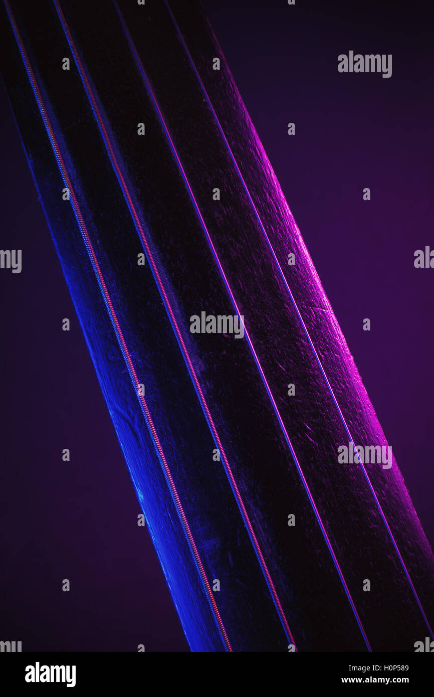 Studio composition of an old dusty violin, blue and purple illumination ...