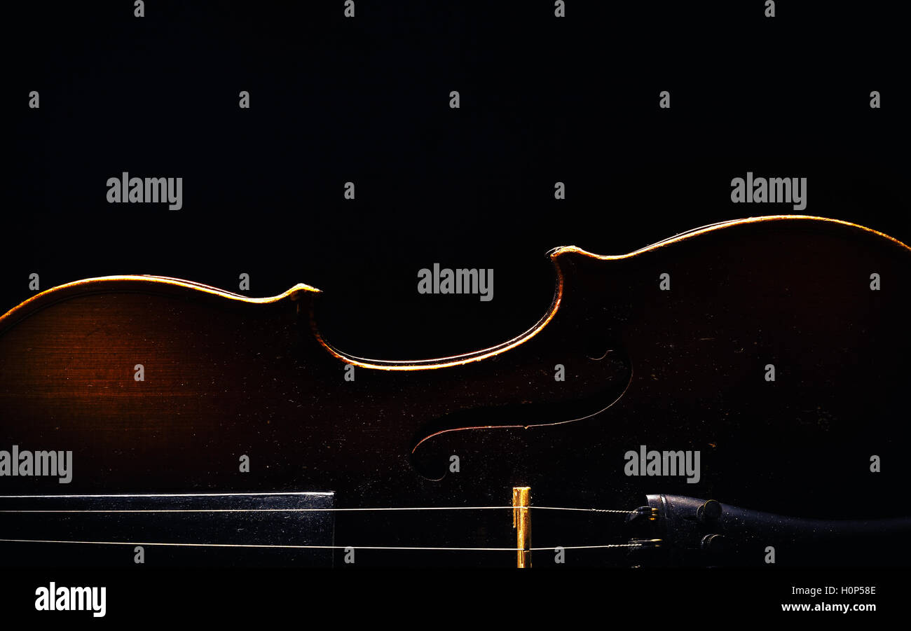Details of an old dusty violin on black background Stock Photo - Alamy