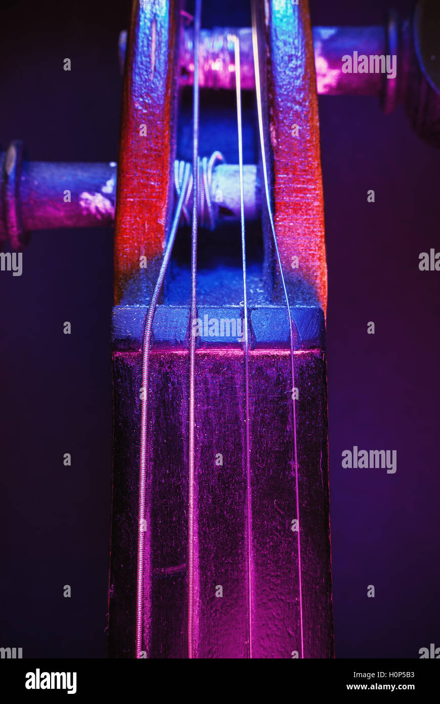 Studio composition of an old dusty violin, blue and purple illumination ...