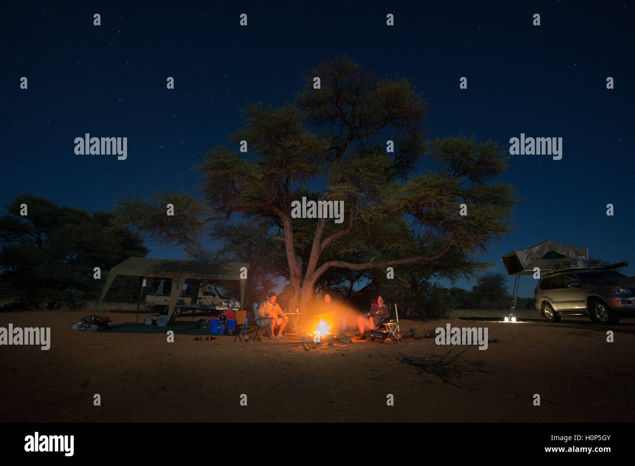 Campers sitting around a camp fire at night in the Kalahari Stock Photo ...