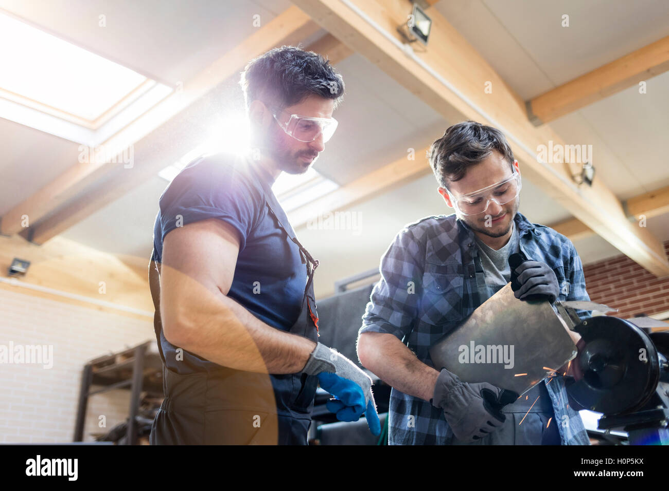 metal worker using sander workshop Stock Photo - Alamy