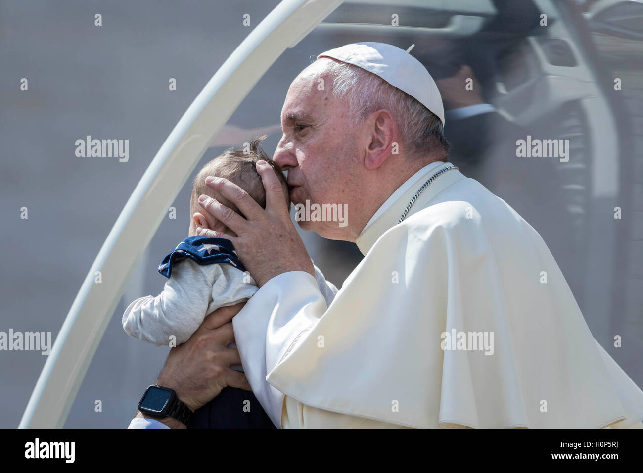 Pope Francis kisses a baby as he leaves at the end of his Weekly ...