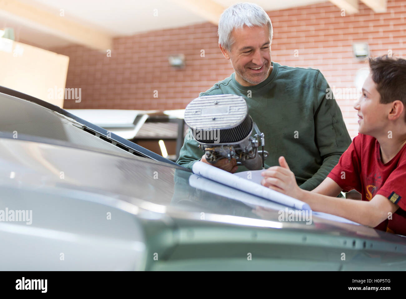 father son rebuilding classic car Stock Photo - Alamy