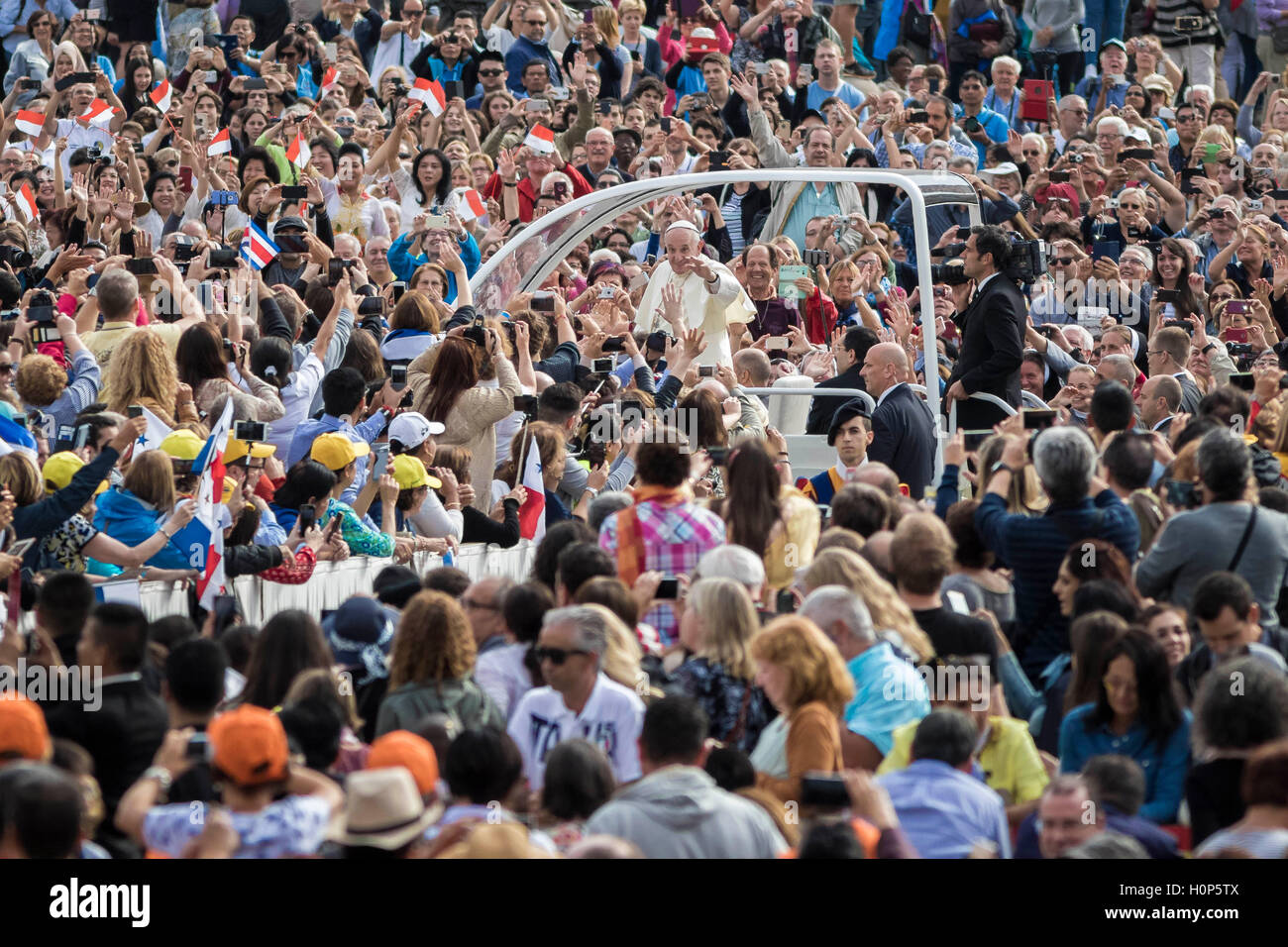 Pope Francis rides on the Popemobile through the crowd of the faithful ...