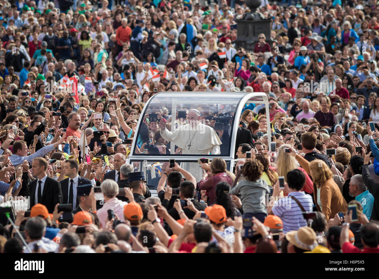 Pope Francis rides on the Popemobile through the crowd of the faithful ...