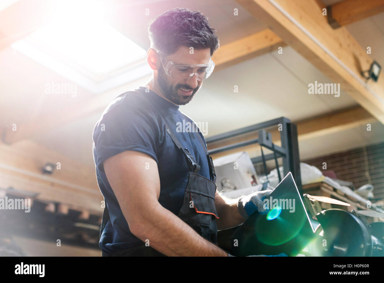 steel worker using sander workshop Stock Photo - Alamy