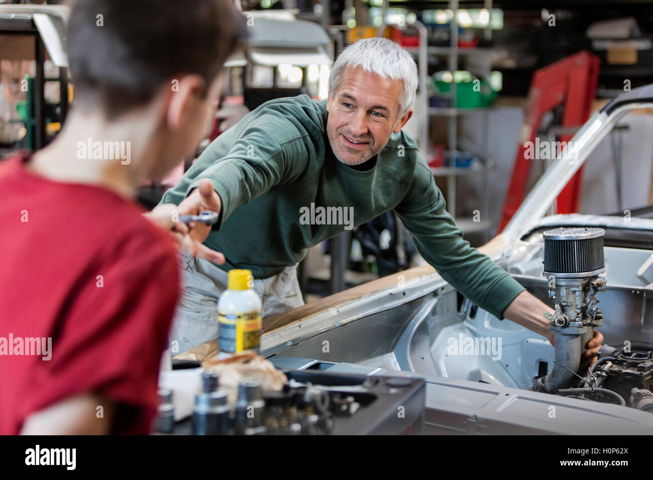 father son rebuilding classic car engine Stock Photo - Alamy
