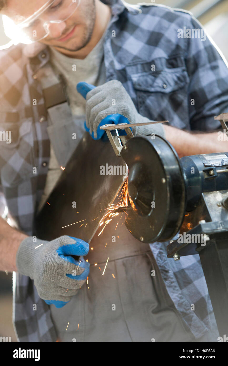 metal worker using sander workshop Stock Photo - Alamy