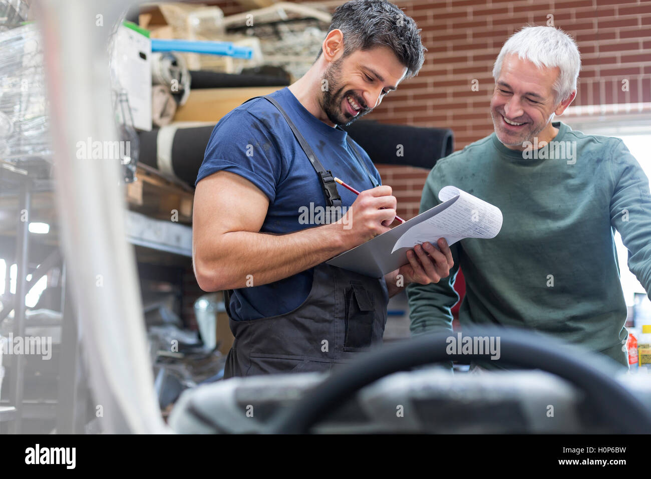 mechanic clipboard working auto repair shop Stock Photo - Alamy