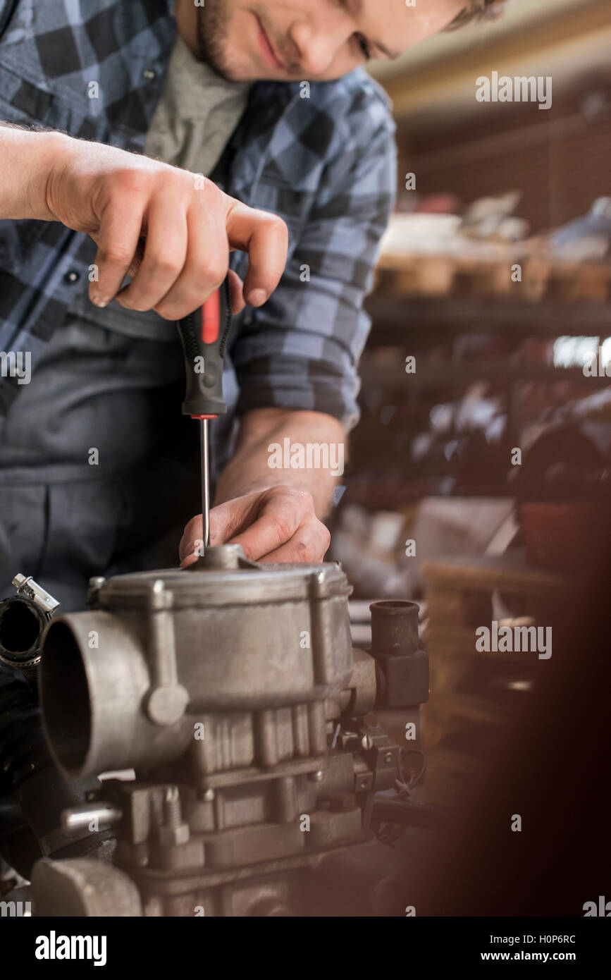 Mechanic using screwdriver engine hi-res stock photography and images ...