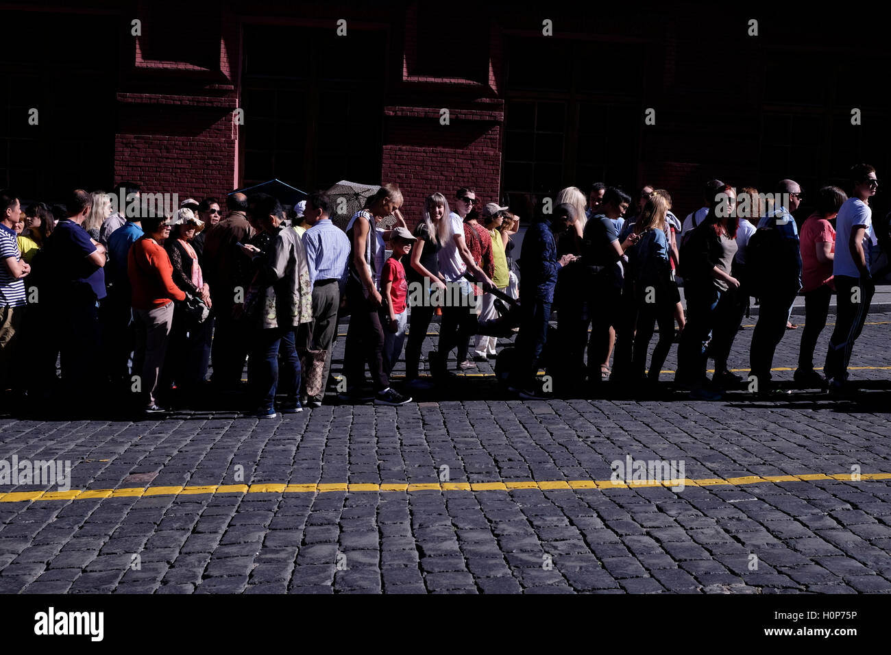 Tourists queue to see Lenin Mausoleum in the red square Moscow Russia ...