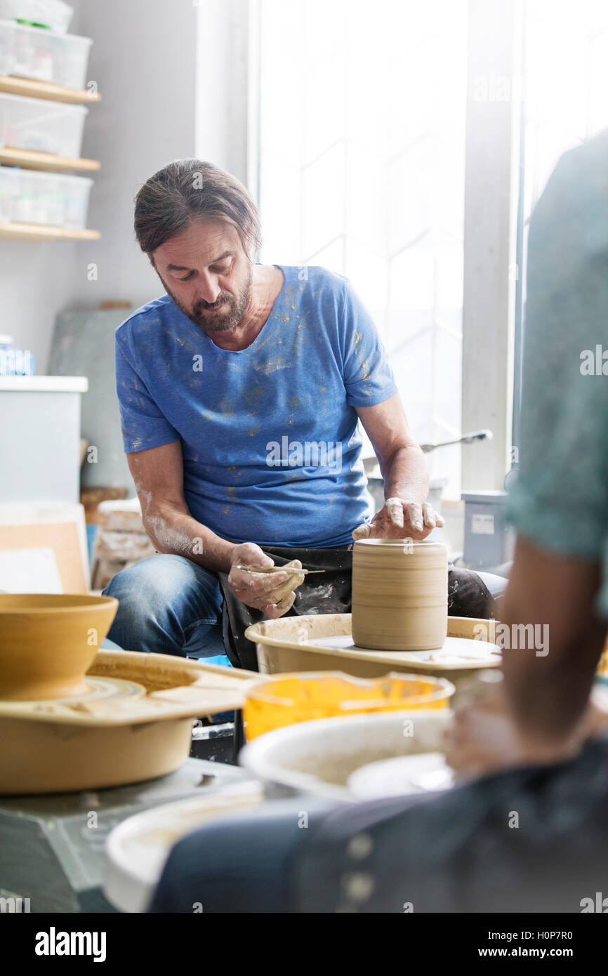 mature man using pottery wheel studio Stock Photo - Alamy