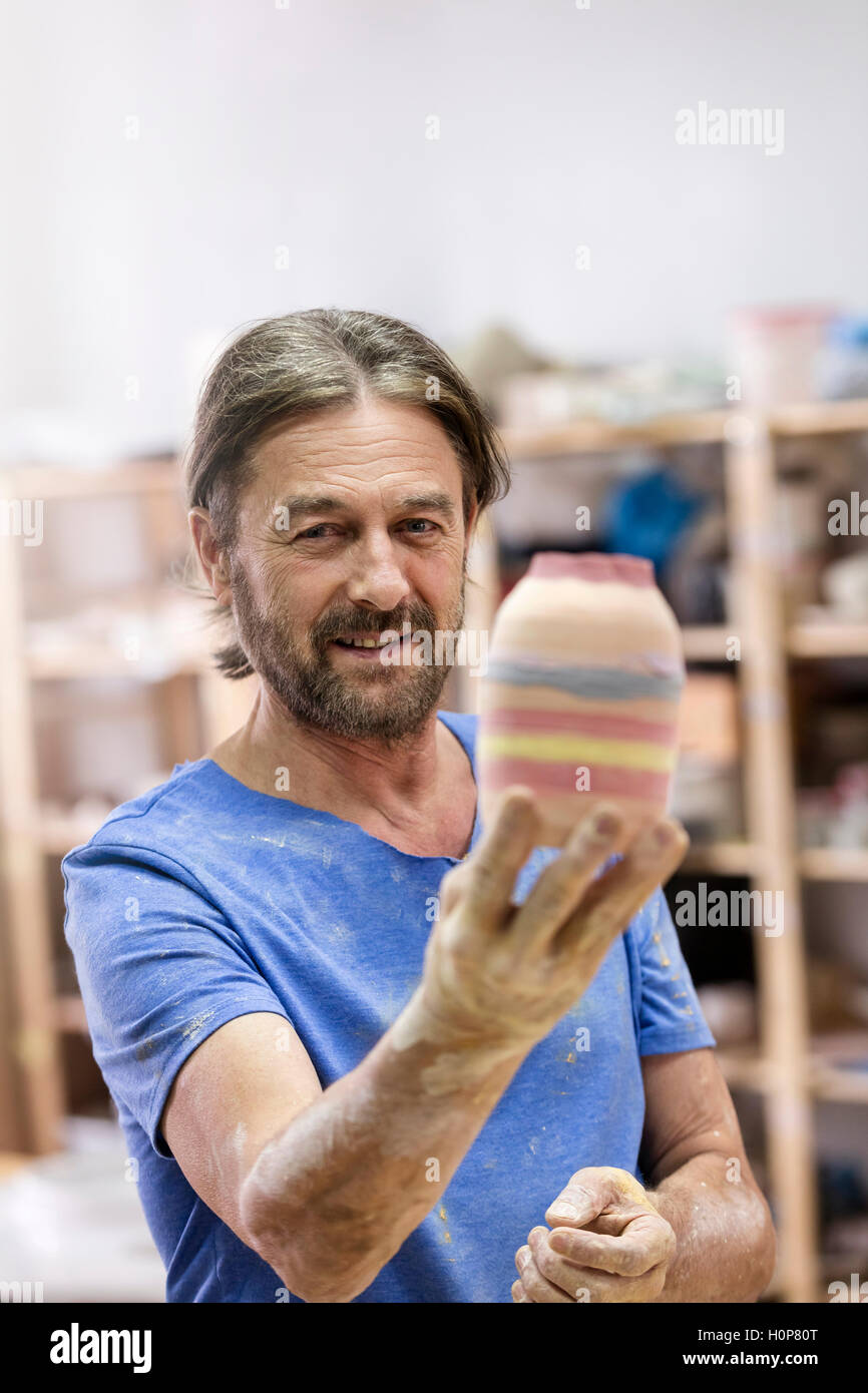portrait mature man painted pottery vase studio Stock Photo - Alamy