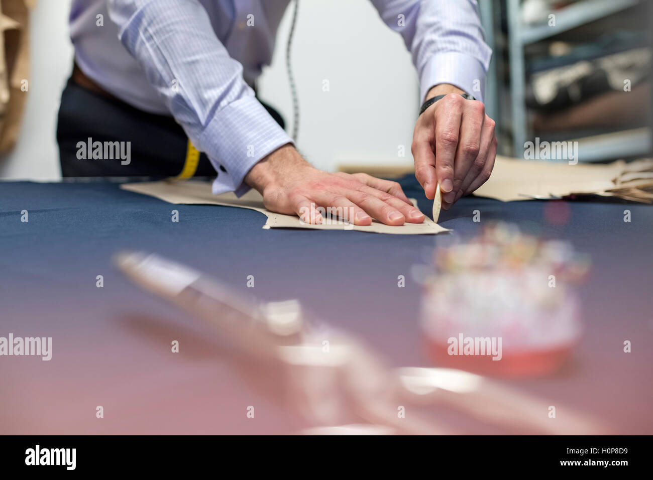tailor marking fabric menswear workshop Stock Photo - Alamy