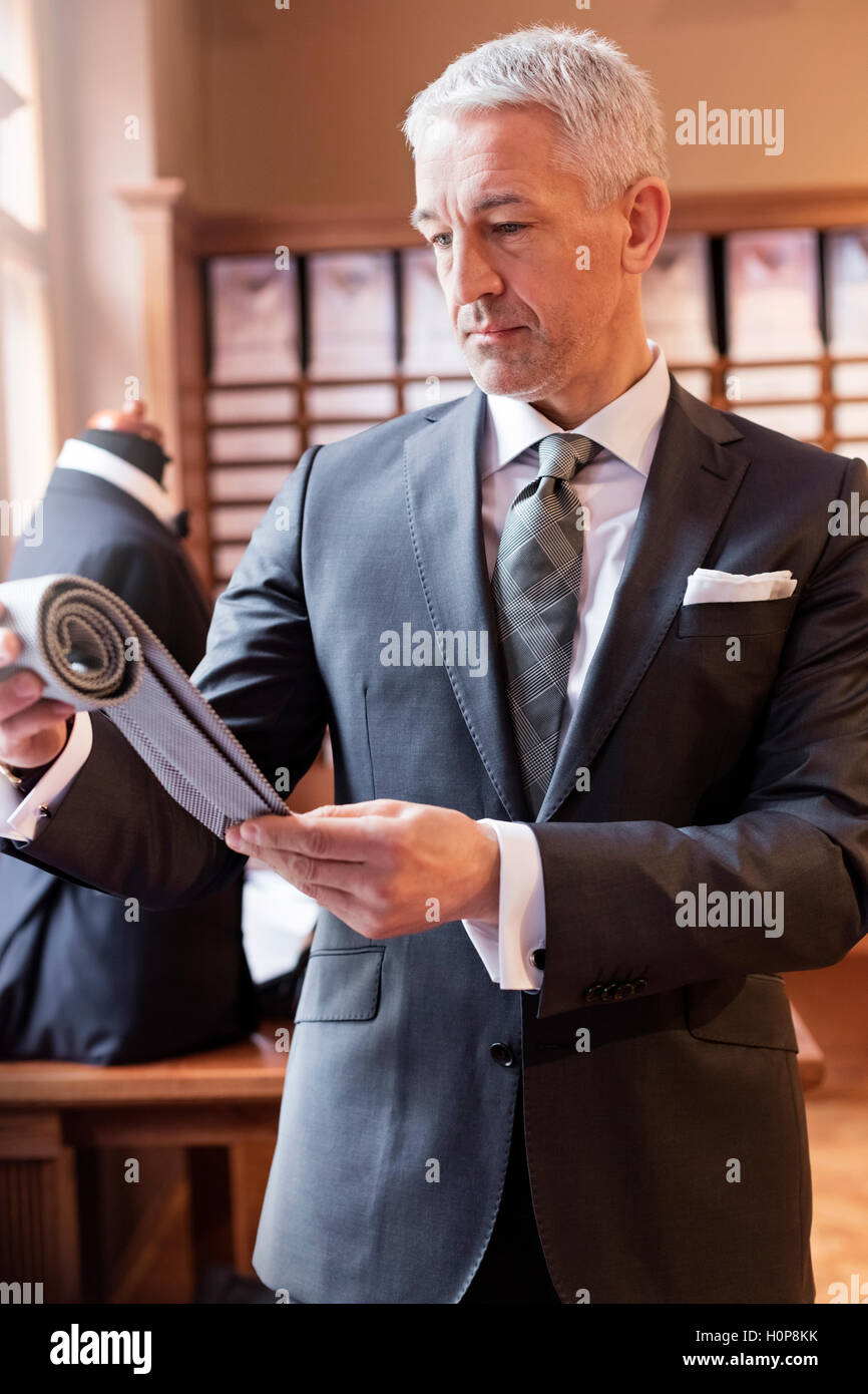 businessman browsing fabric menswear shop Stock Photo - Alamy